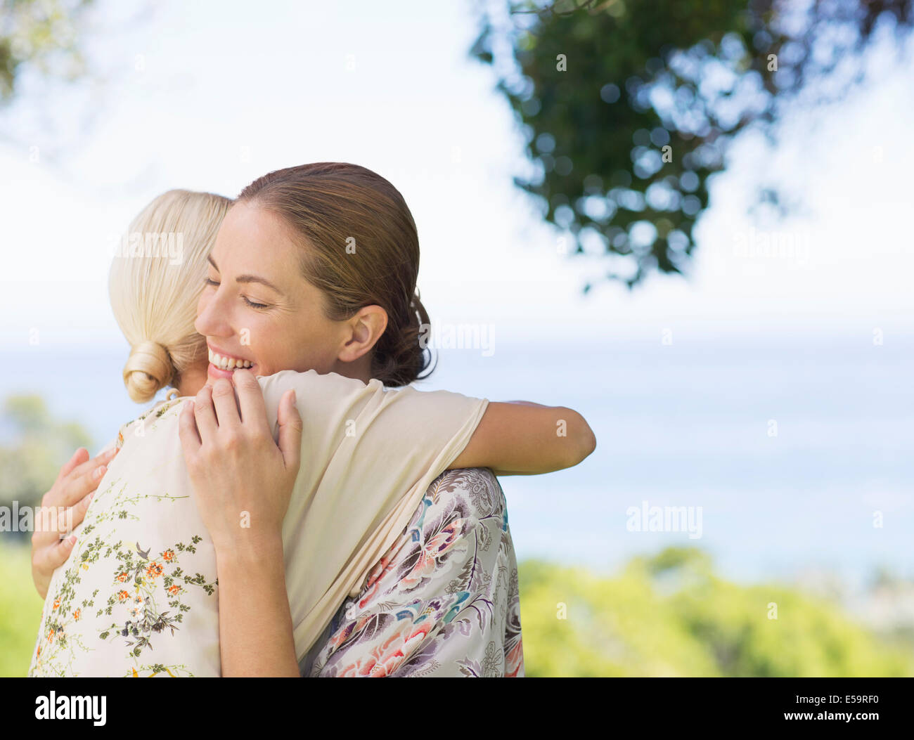 Women hugging outdoors Stock Photo - Alamy