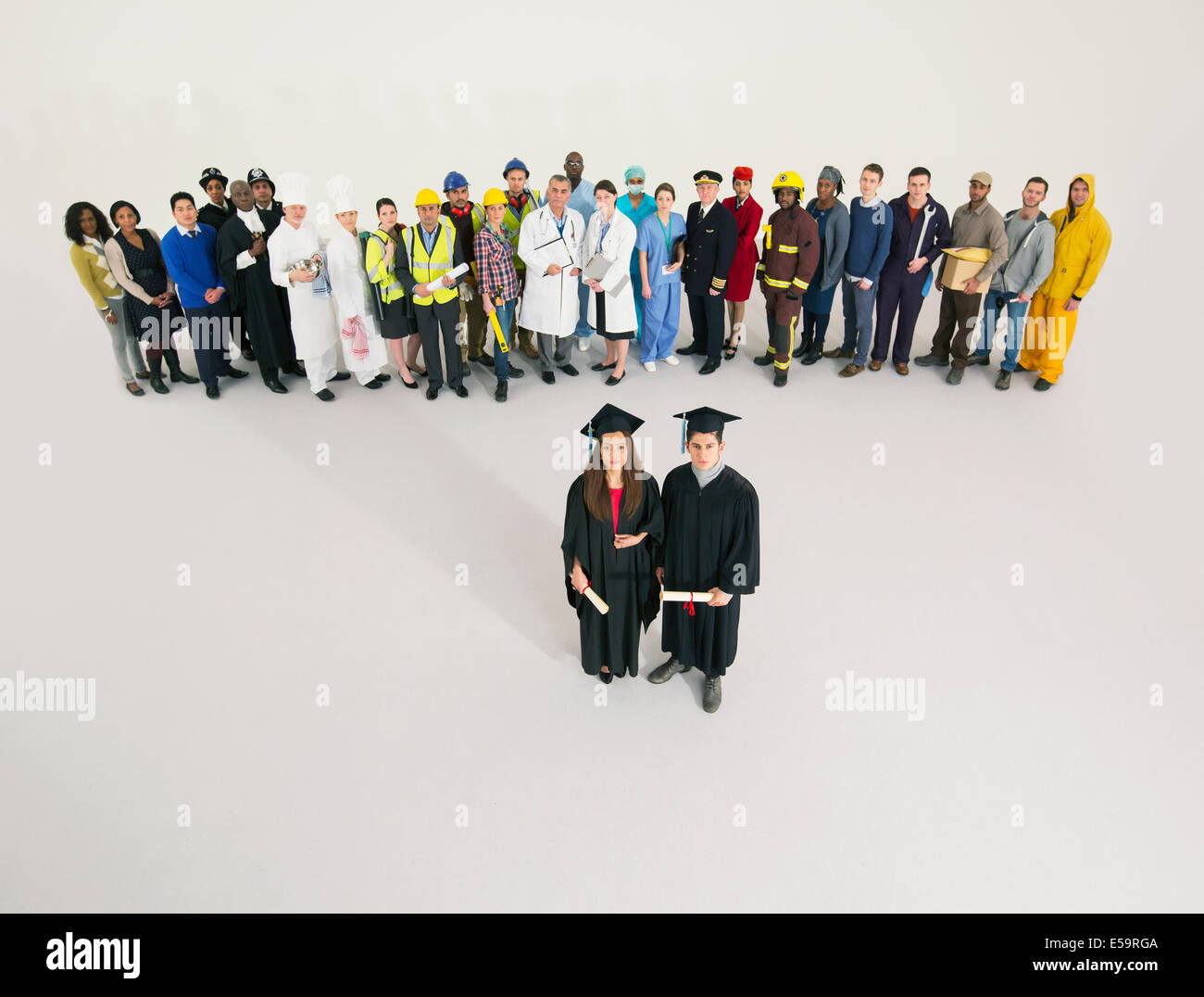 Portrait of graduates with workers in background Stock Photo - Alamy