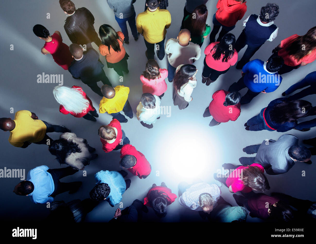 Business people with backs turned on bright light Stock Photo - Alamy