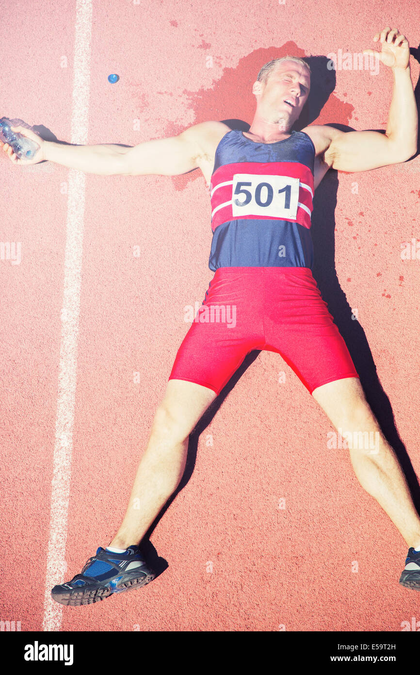 Runner laying on track Stock Photo - Alamy