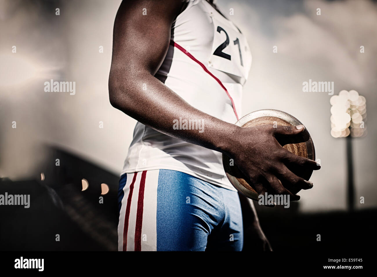 Track and field athlete holding discus Stock Photo - Alamy