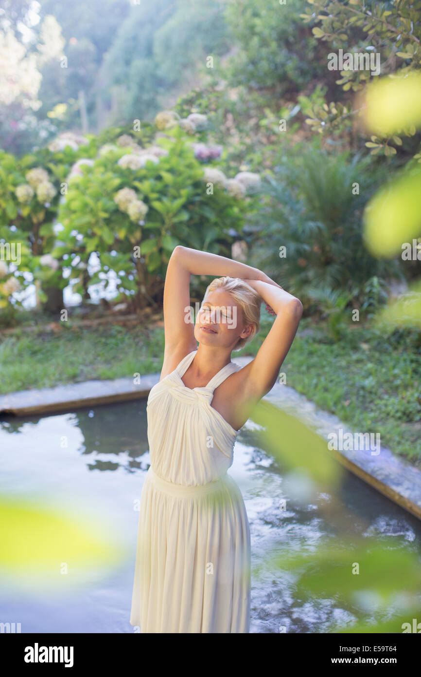 Woman standing by pool outdoors Stock Photo - Alamy