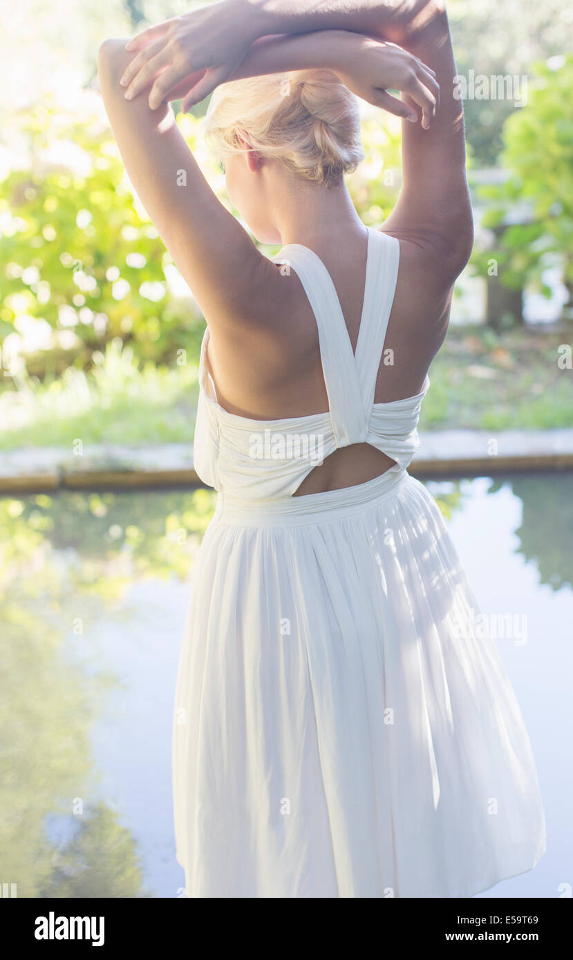 Woman standing by pool outdoors Stock Photo - Alamy
