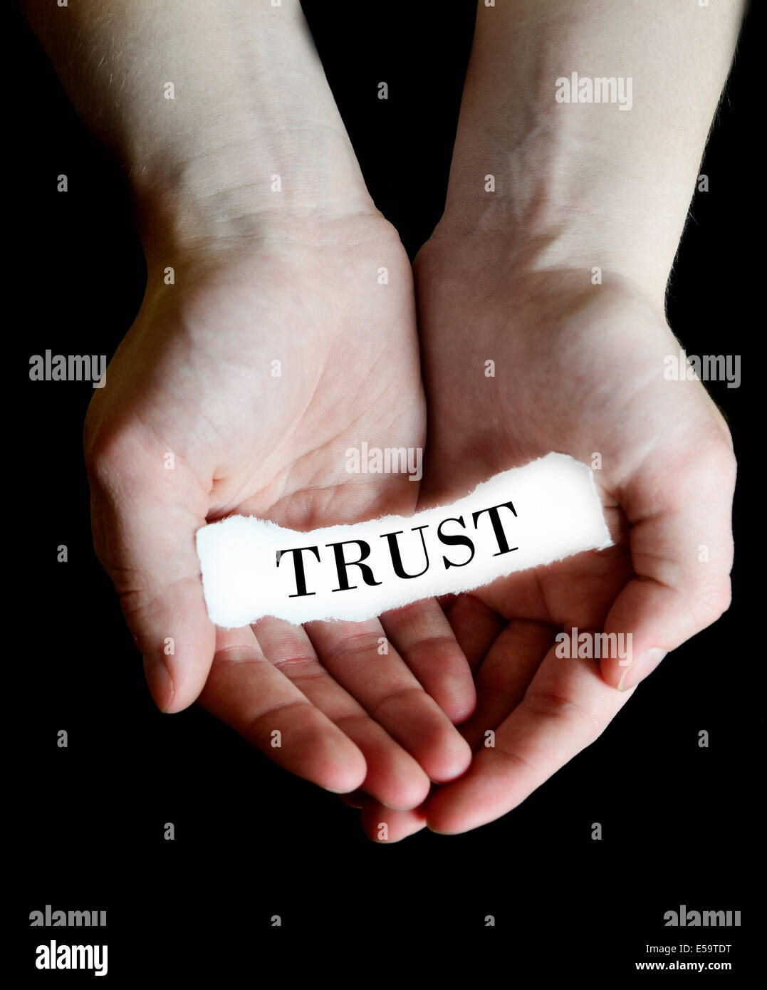 Person hands holding cupping paper message for Trust Stock Photo - Alamy