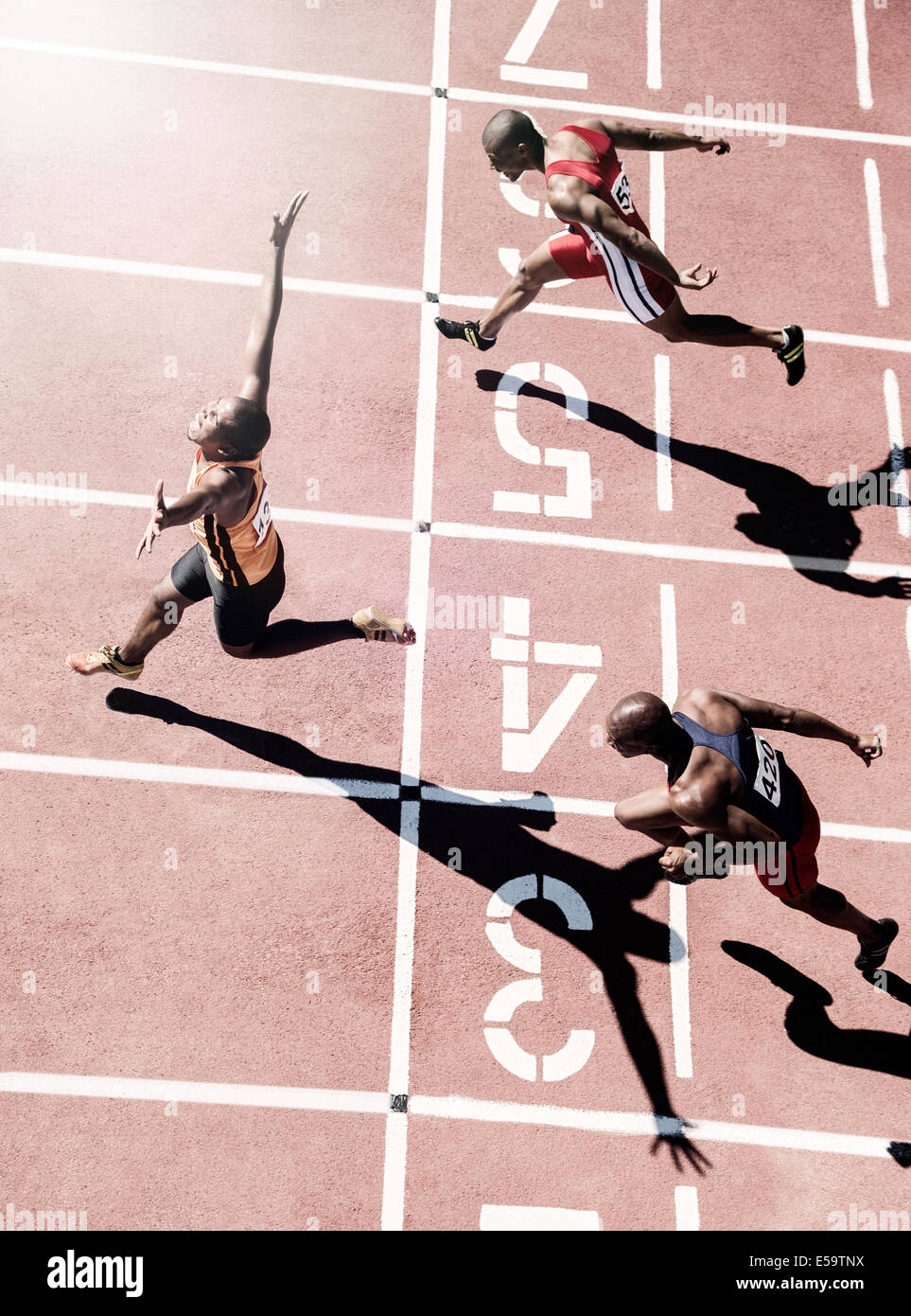 Runner crossing finish line hi-res stock photography and images - Alamy