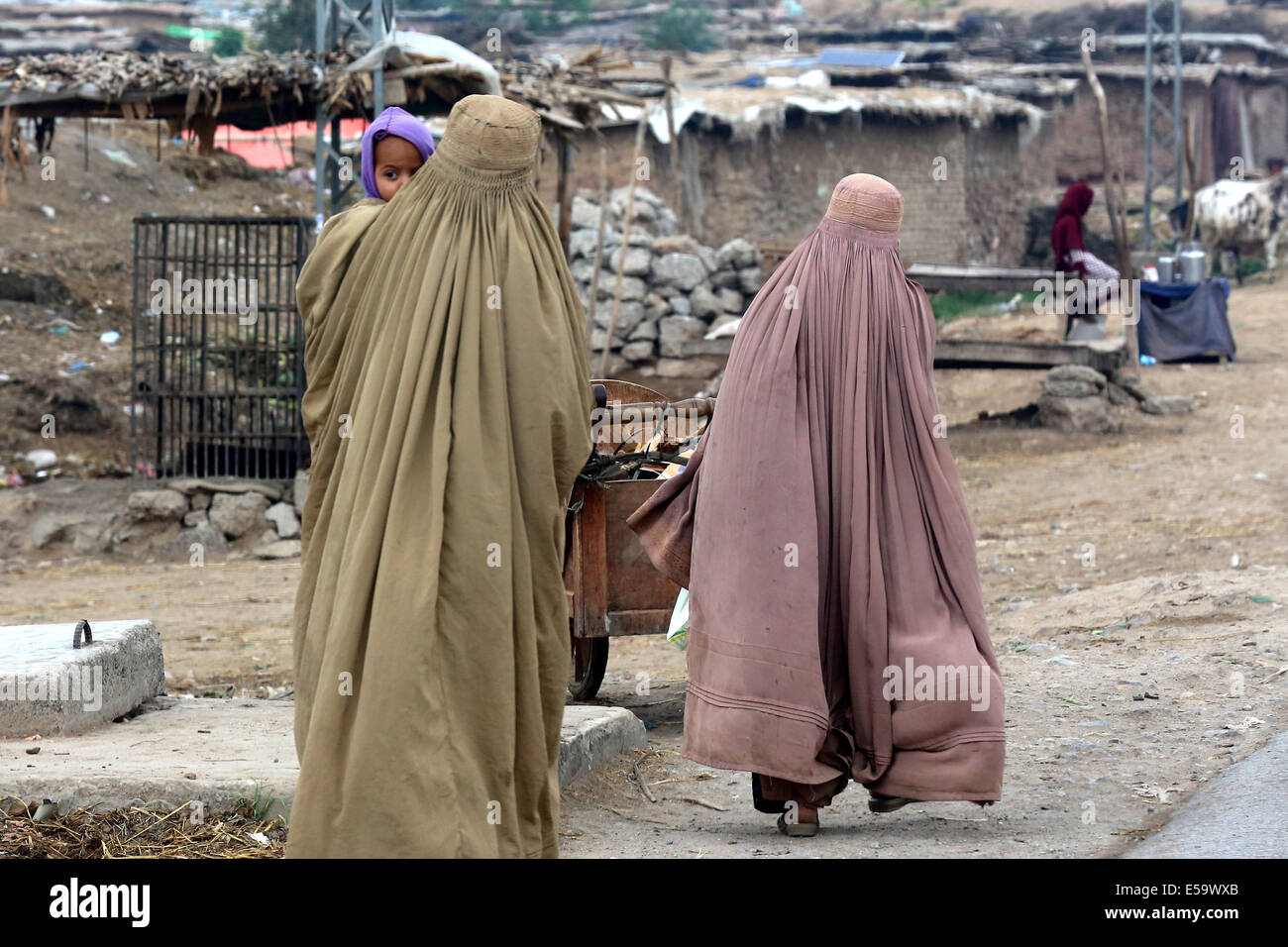 Afghan refugee women with her children in a refugee camp in Islamabad ...