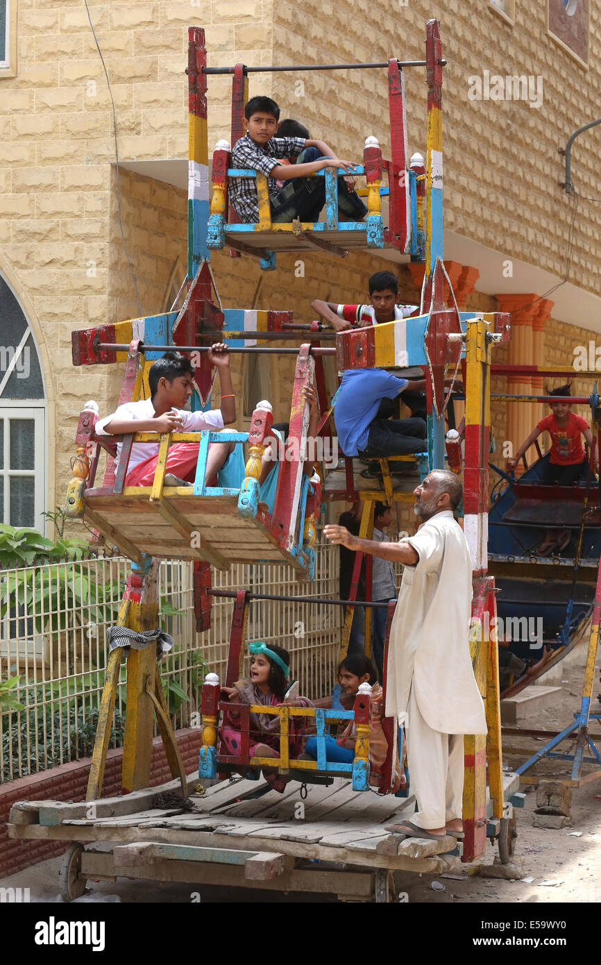 children on a old wooden merry-go-round in Karachi, Pakistan Stock ...