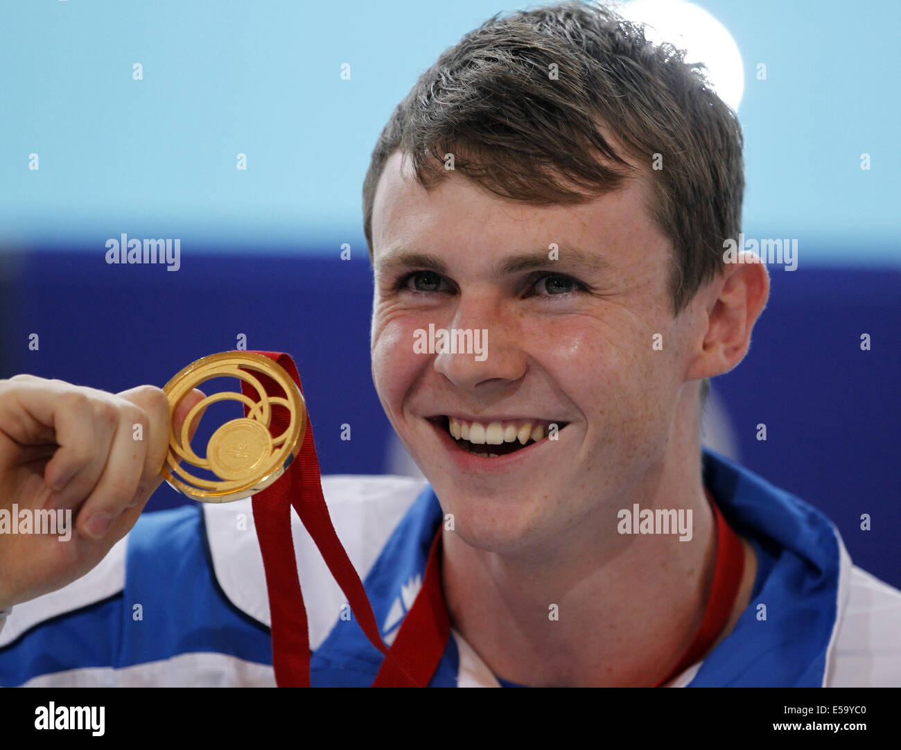 Glasgow. 24th July, 2014. Ross Murdoch of Scotland shows his gold medal ...