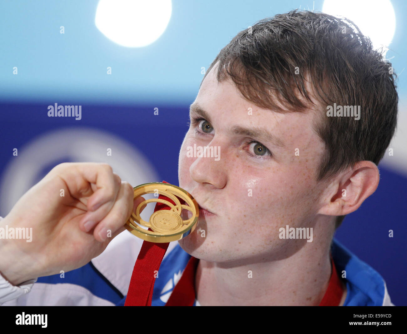 Glasgow. 24th July, 2014. Ross Murdoch of Scotland kisses his gold ...