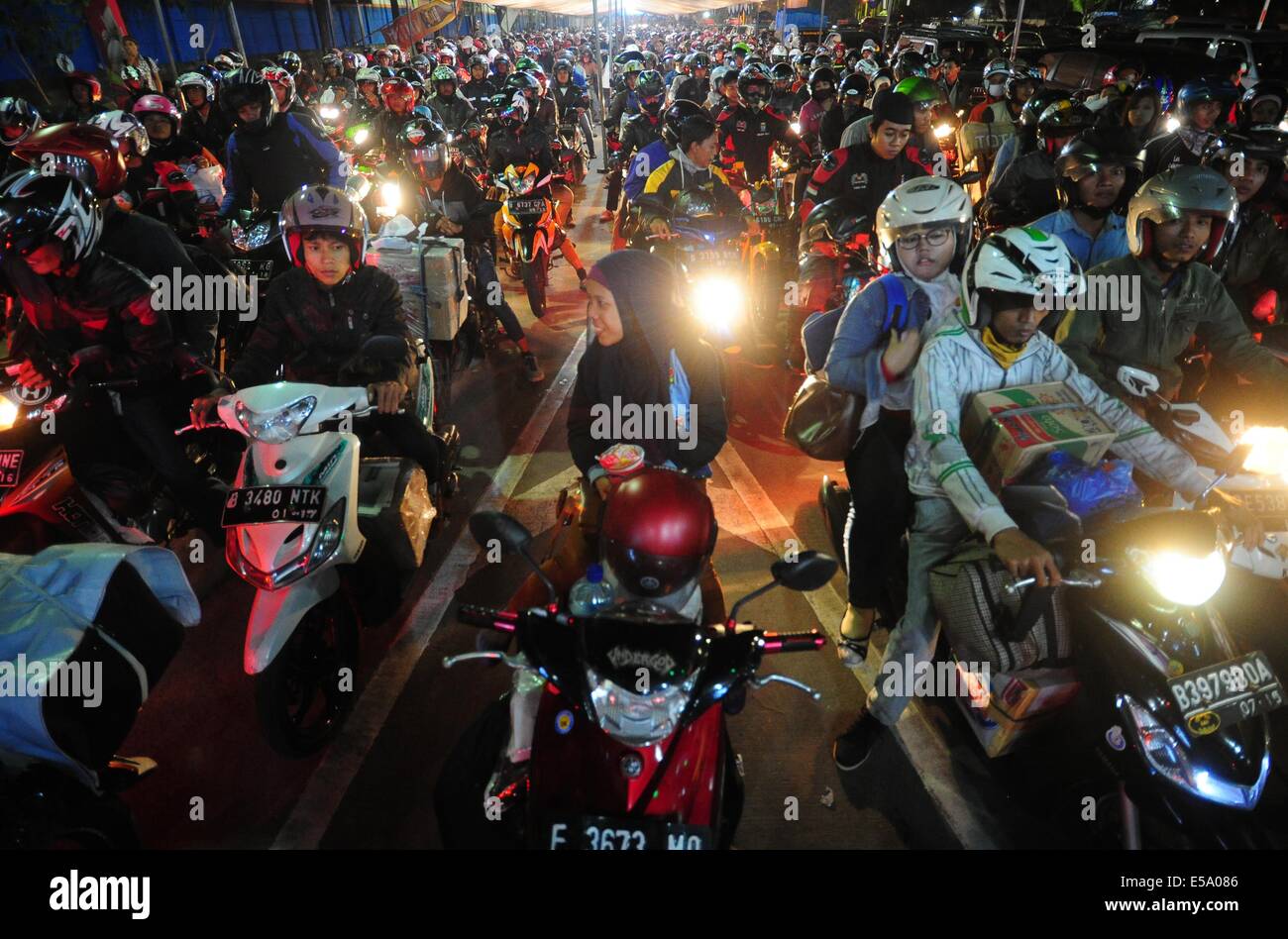 Jakarta, Indonesia. 25th July, 2014. Riders on their motorbikes queue ...
