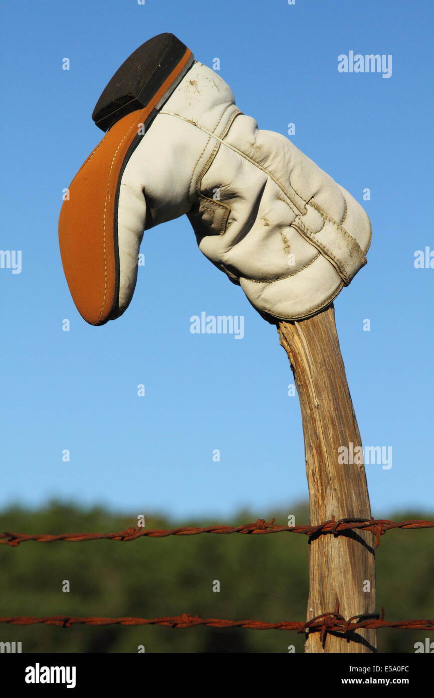 An old retired boot atop a wooden fence post Stock Photo - Alamy