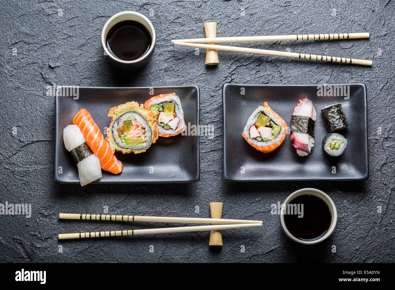 Sushi for two served in a black ceramic Stock Photo - Alamy