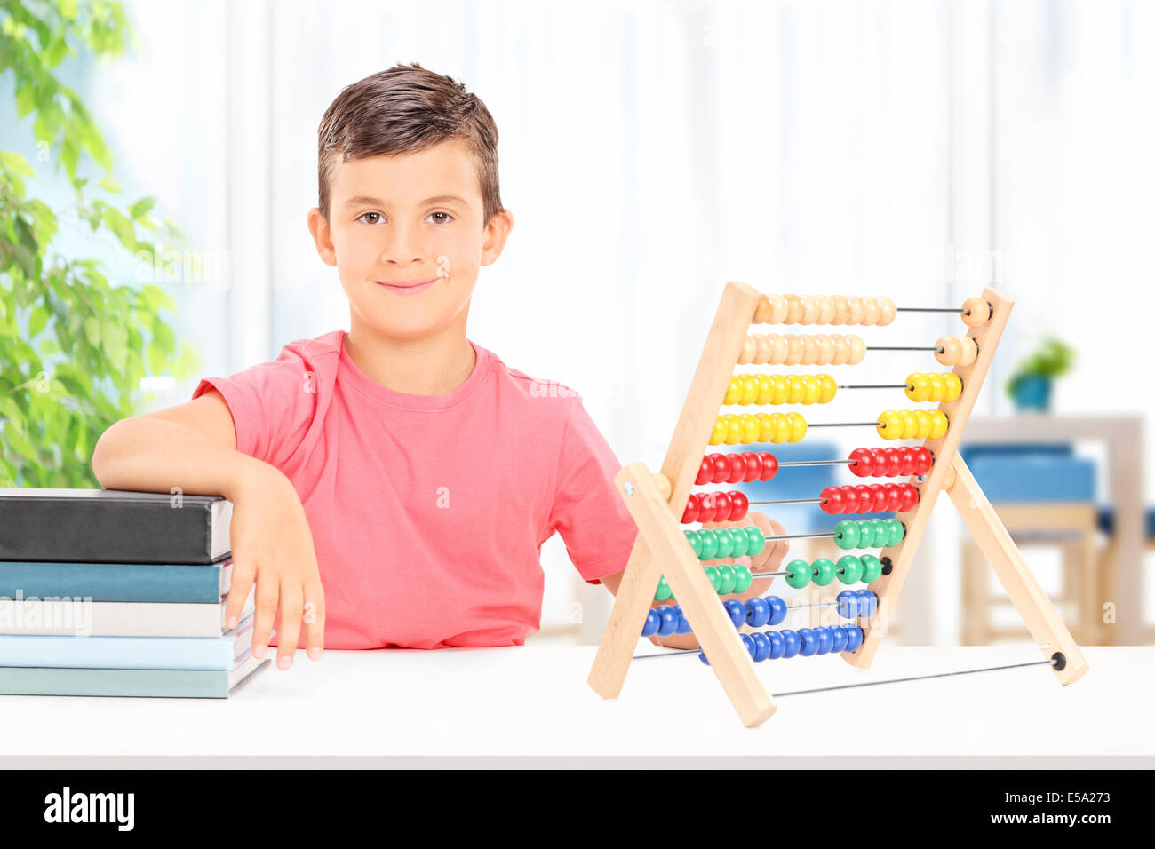 Boy counting on an abacus at home seated Stock Photo - Alamy