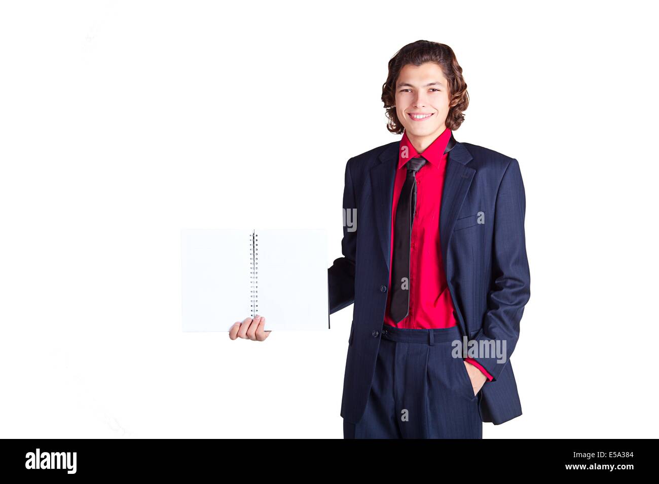 student stands with notebook in gray suit and red shirt on white ...