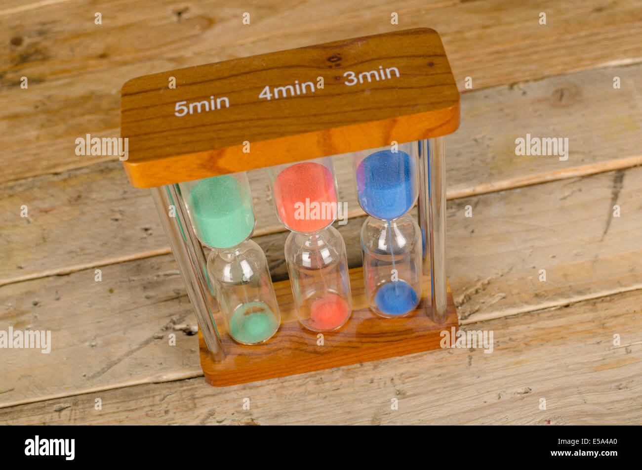 Multiple hourglass with colorful sand running Stock Photo - Alamy