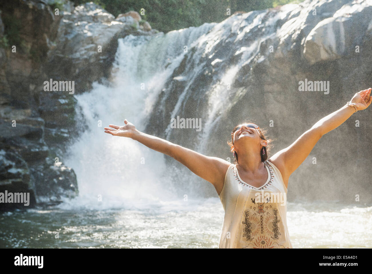 Woman standing waterfall hi-res stock photography and images - Alamy