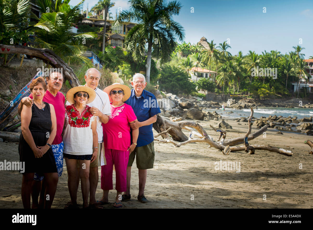 Hispanic friends smiling together on beach Stock Photo - Alamy