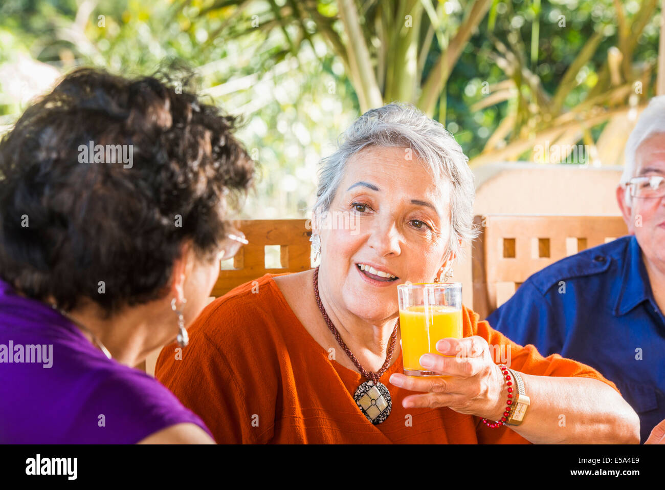 Hispanic women talking at table Stock Photo - Alamy