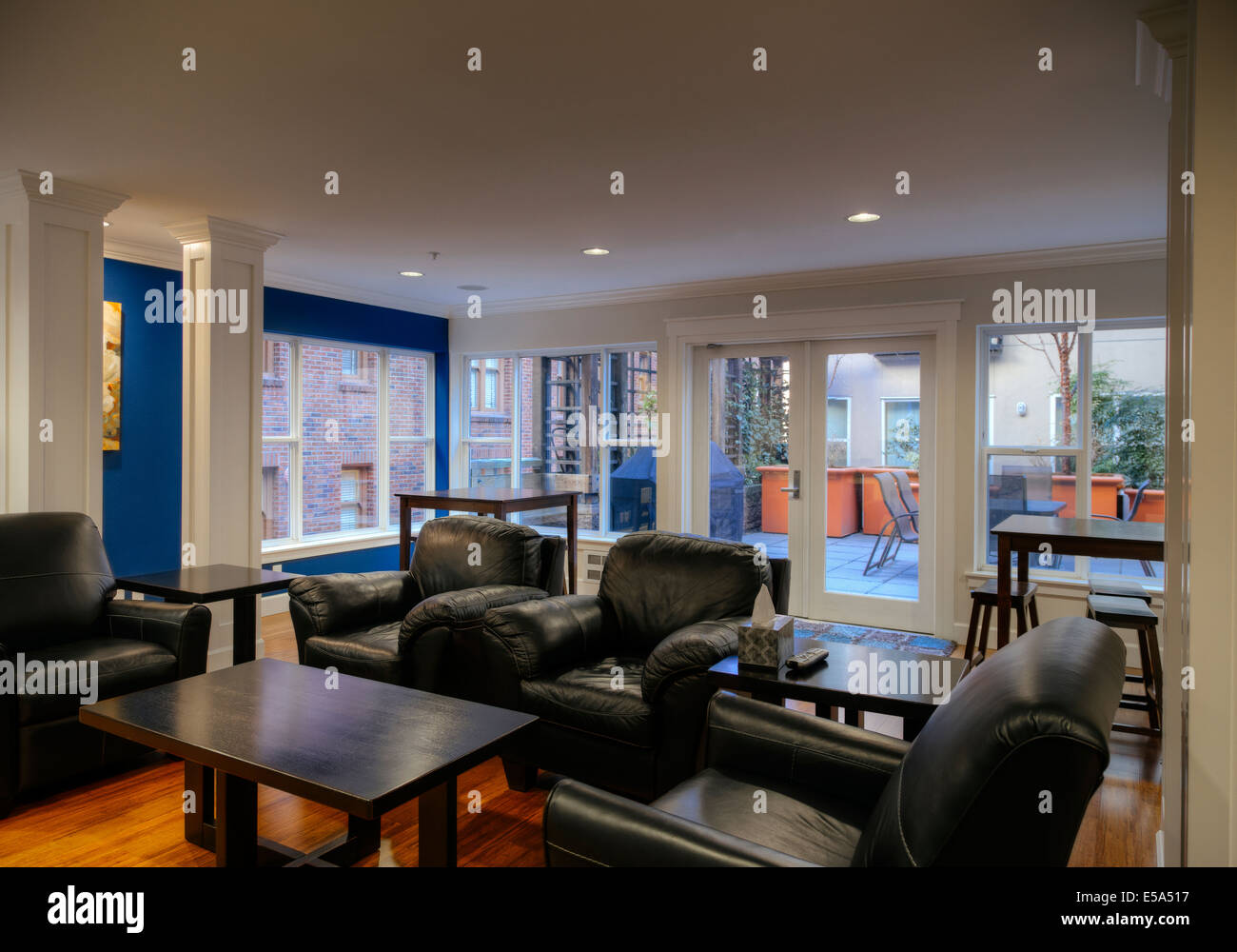 Armchairs and coffee tables in common area Stock Photo - Alamy