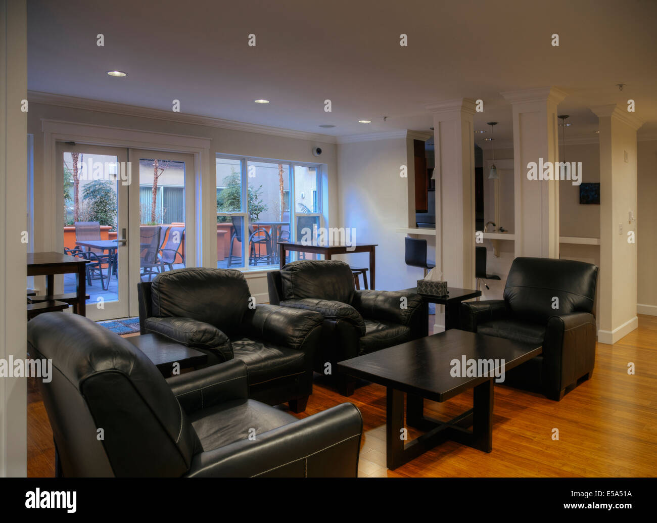 Armchairs and coffee tables in common area Stock Photo - Alamy