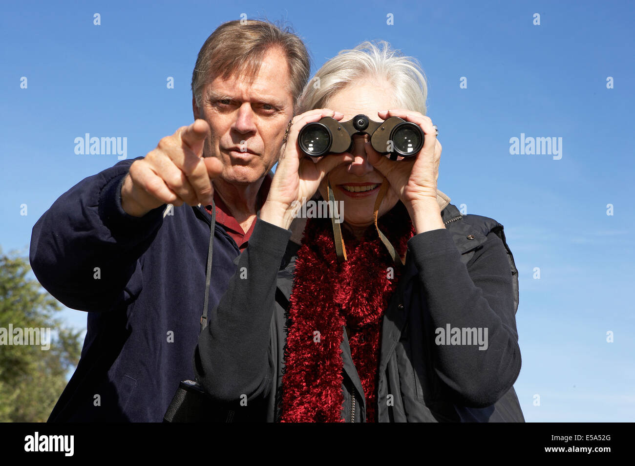 Senior Caucasian couple using binoculars outdoors Stock Photo - Alamy