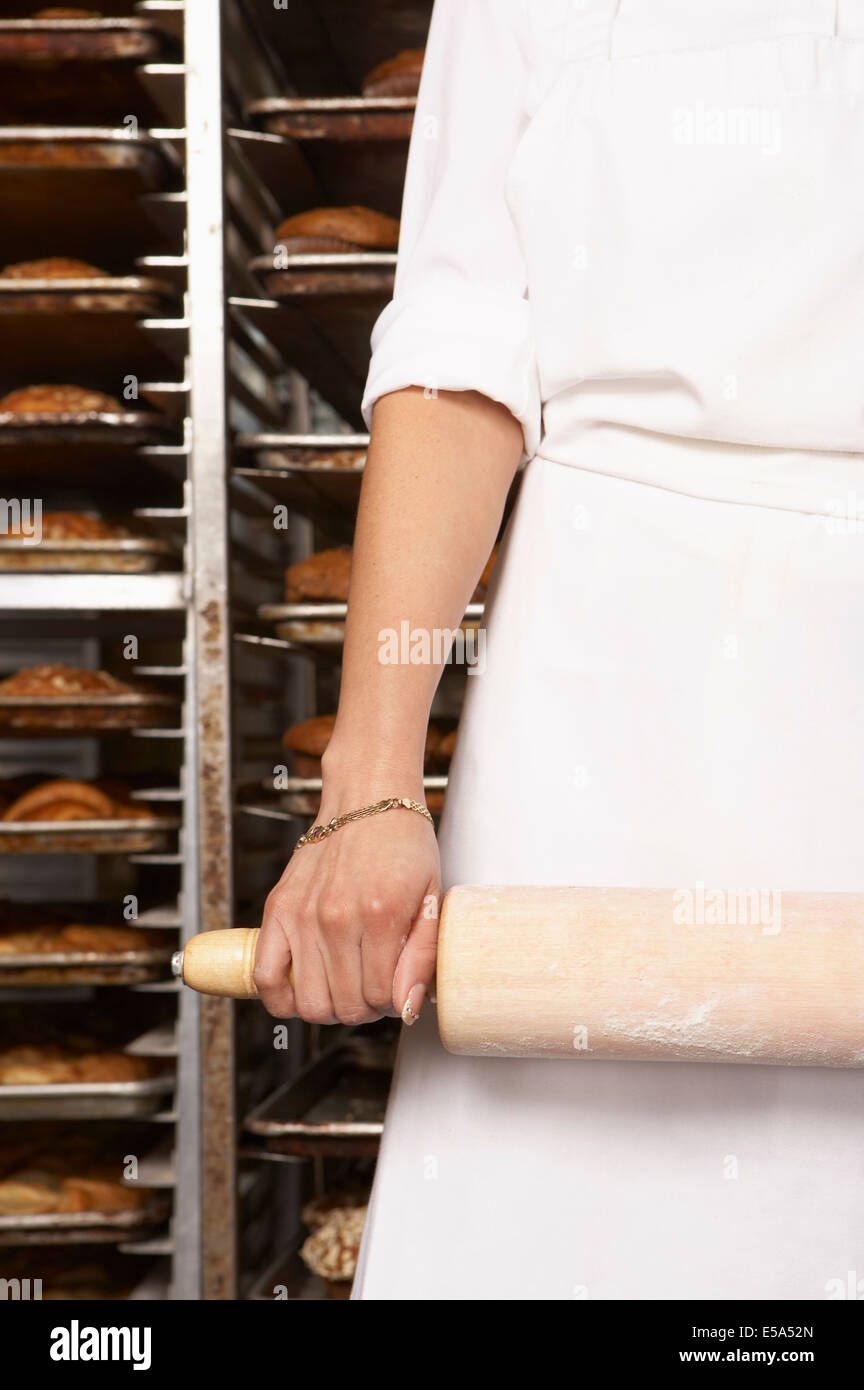Hispanic baker holding rolling pin in bakery Stock Photo - Alamy
