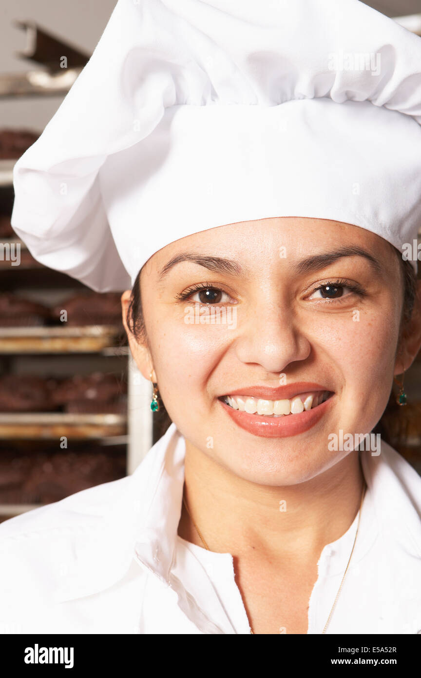 Hispanic baker smiling Stock Photo - Alamy