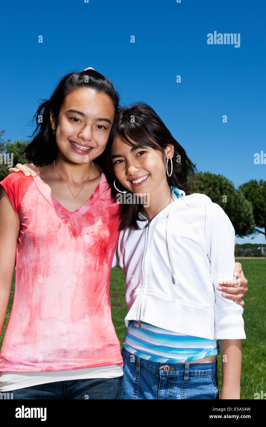 Chinese girls hugging outdoors Stock Photo - Alamy
