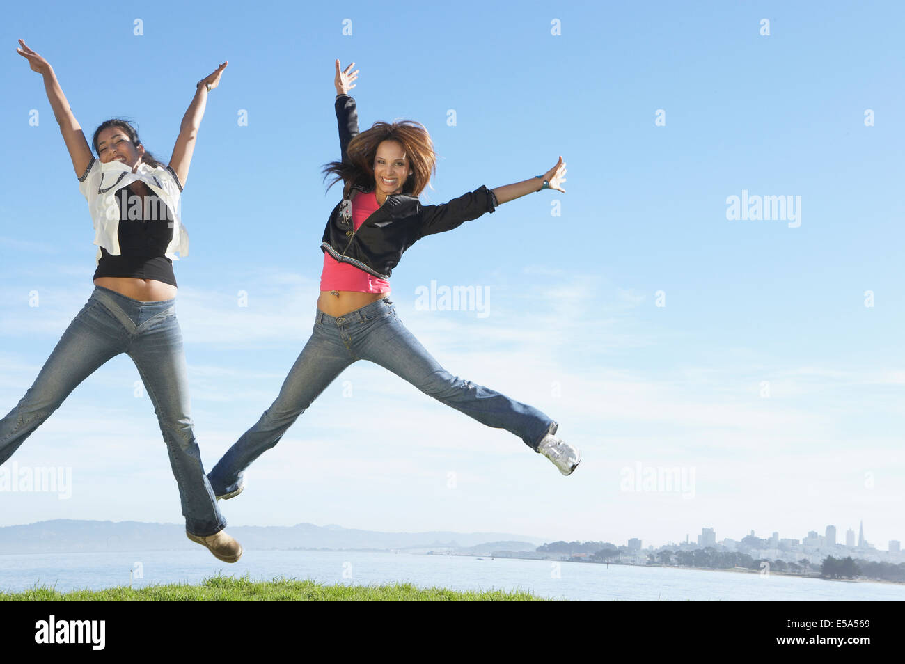 Women jumping for joy on hilltop Stock Photo - Alamy