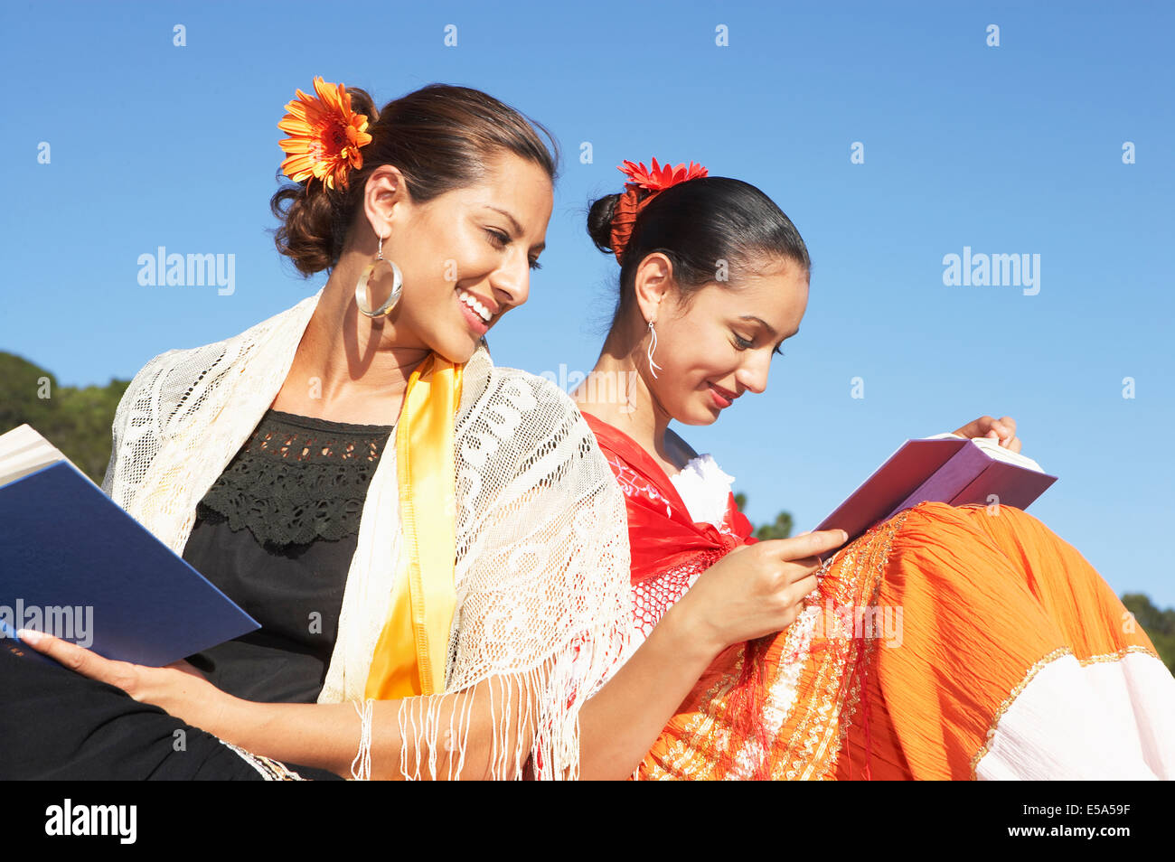 Hispanic women reading in traditional clothing Stock Photo - Alamy
