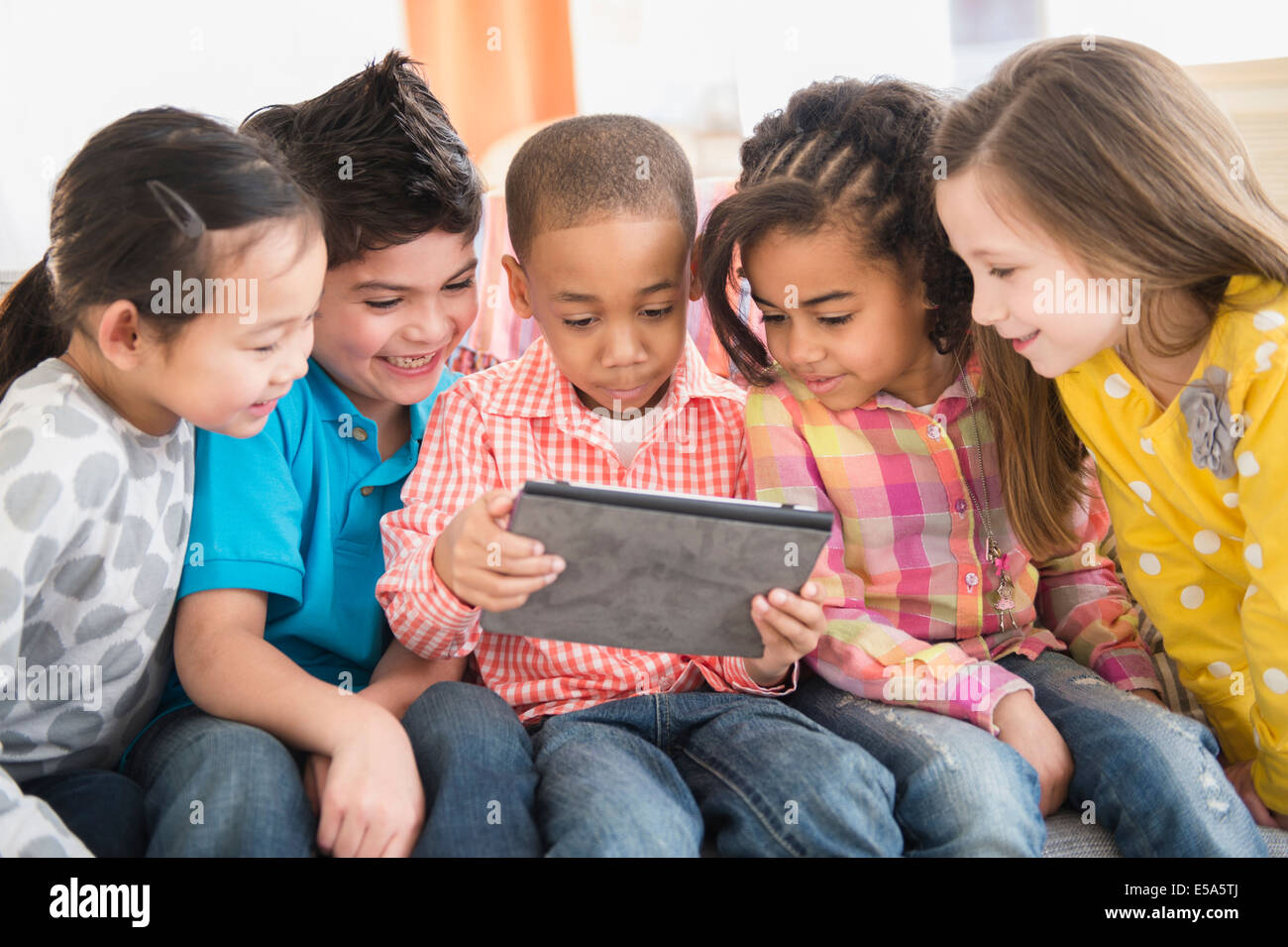 Children using digital tablet together Stock Photo - Alamy