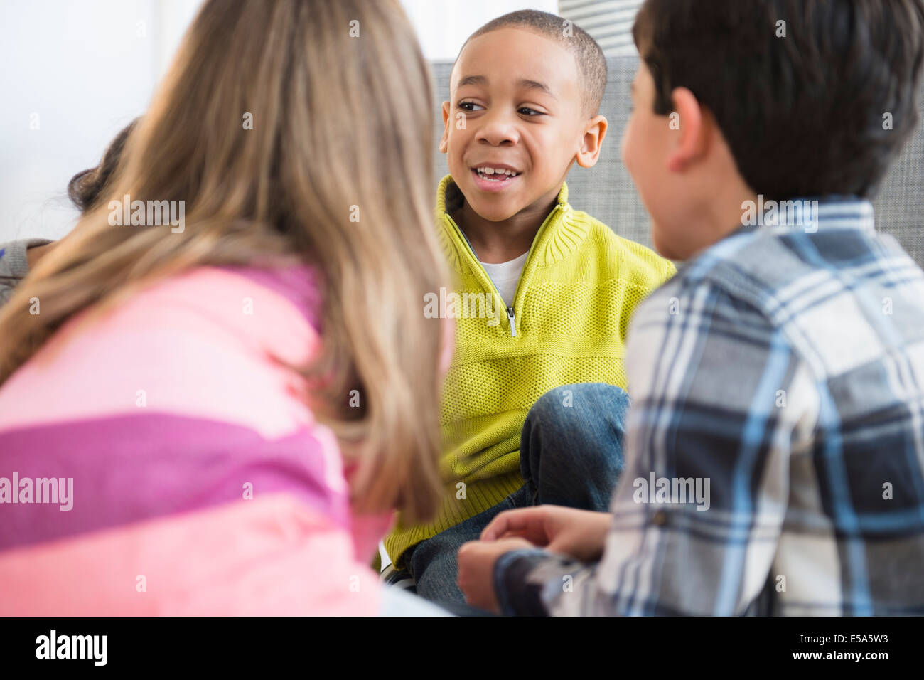 Children talking in living room Stock Photo - Alamy