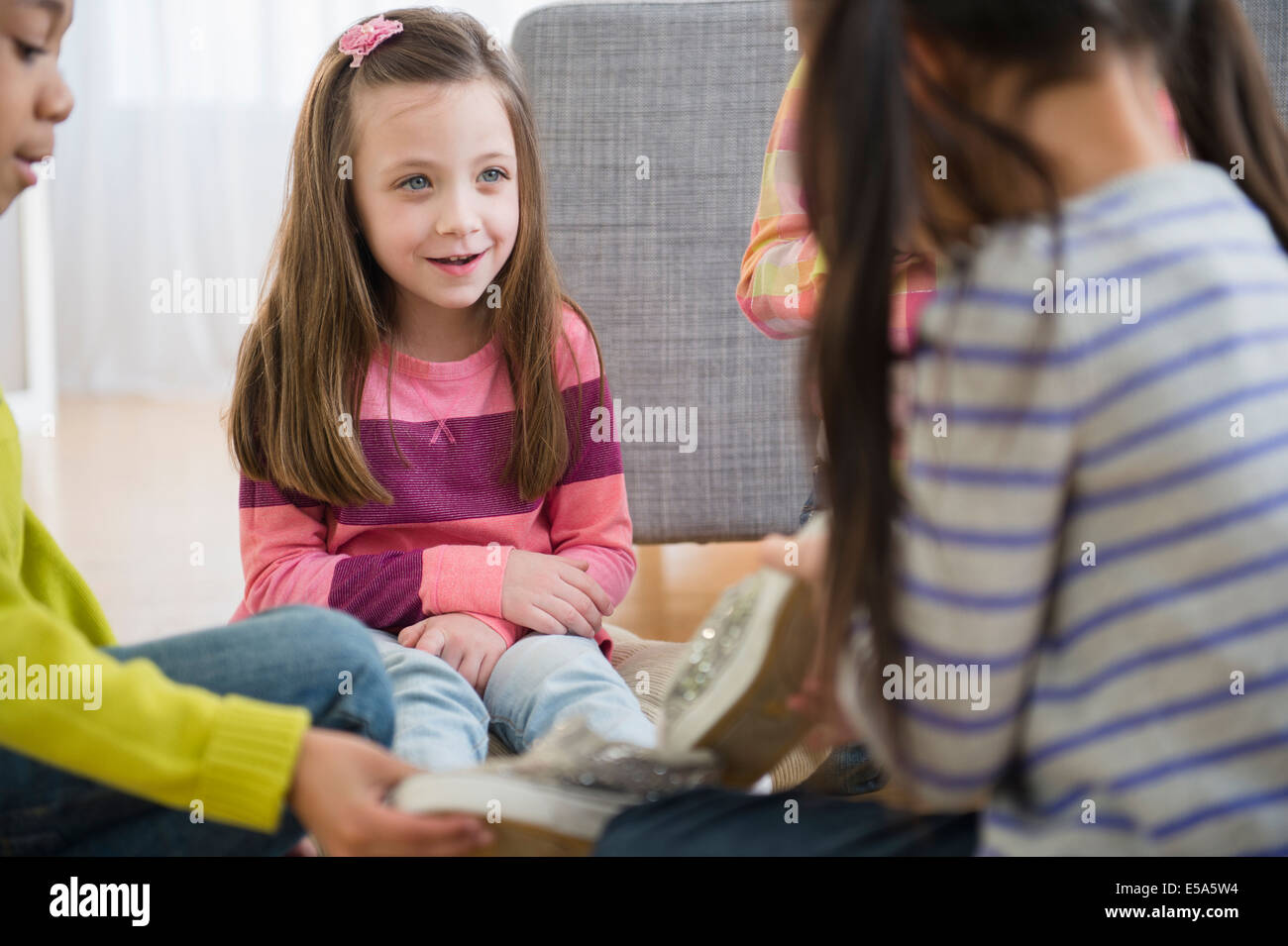 Children talking in living room Stock Photo - Alamy
