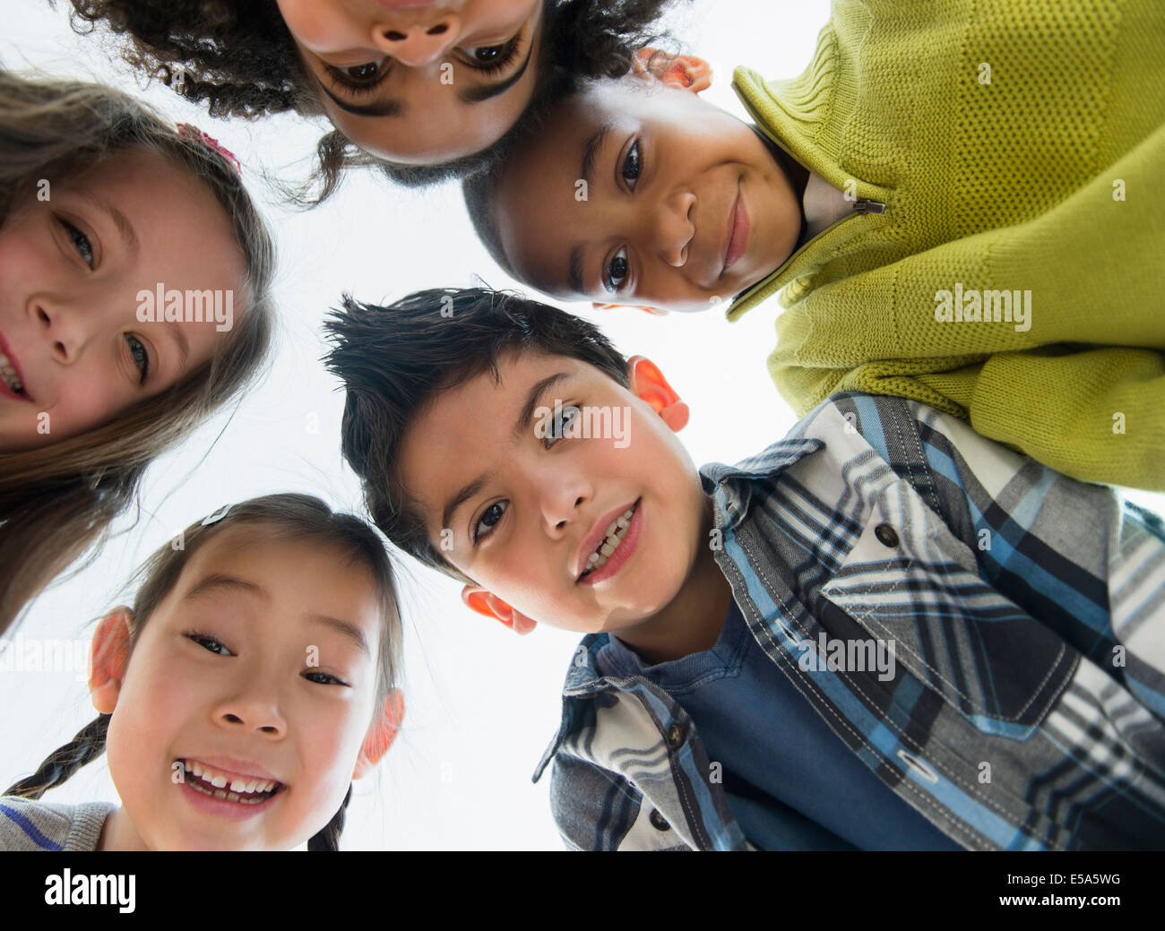 Children smiling in huddle Stock Photo - Alamy