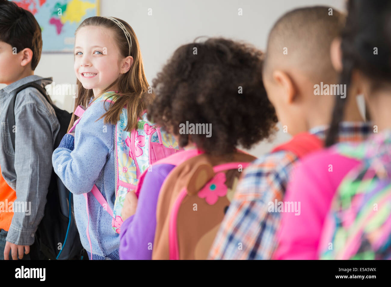 Students standing in line in classroom Stock Photo - Alamy