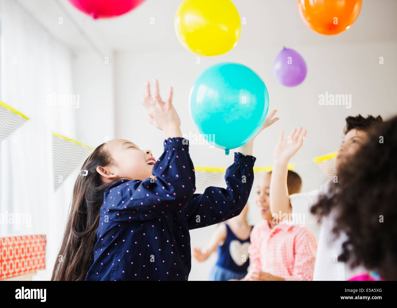 Children playing with balloons hi-res stock photography and images - Alamy
