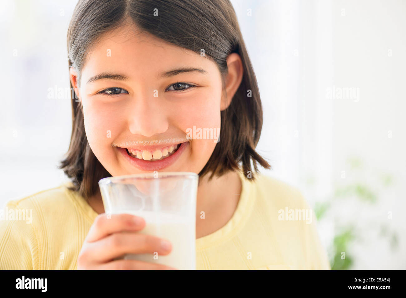 Hispanic girl drinking glass of milk Stock Photo - Alamy
