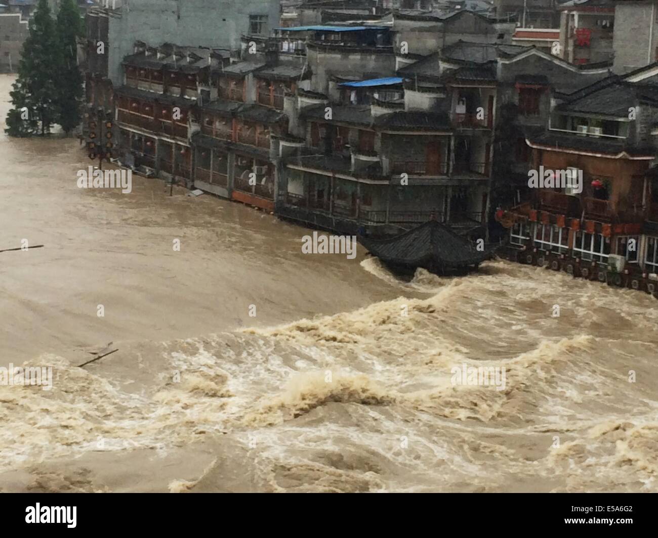 Buildings are submerged by flood water at the Fenghuang Ancient Town on ...