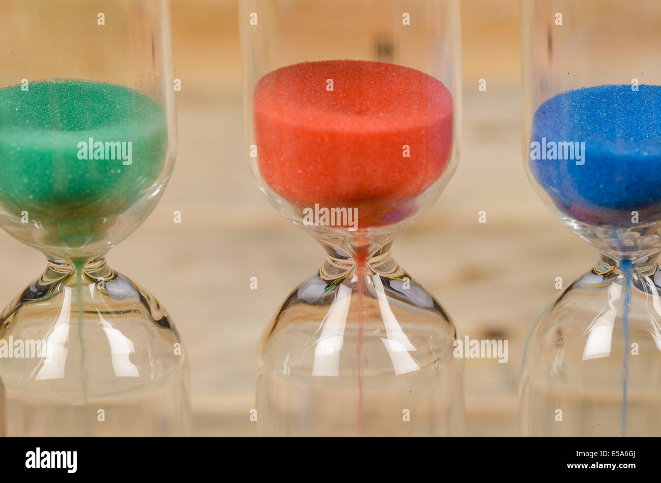 Multiple hourglass with colorful sand running Stock Photo - Alamy