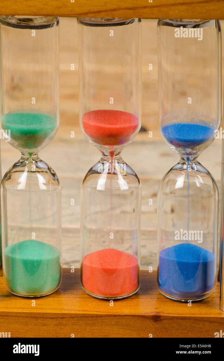 Multiple hourglass with colorful sand running Stock Photo - Alamy