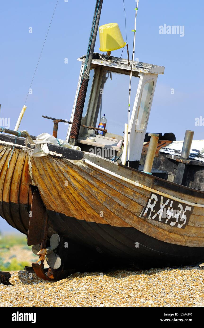 Clinker built fishing boat on shingle beach at Dungeness, Kent, England ...