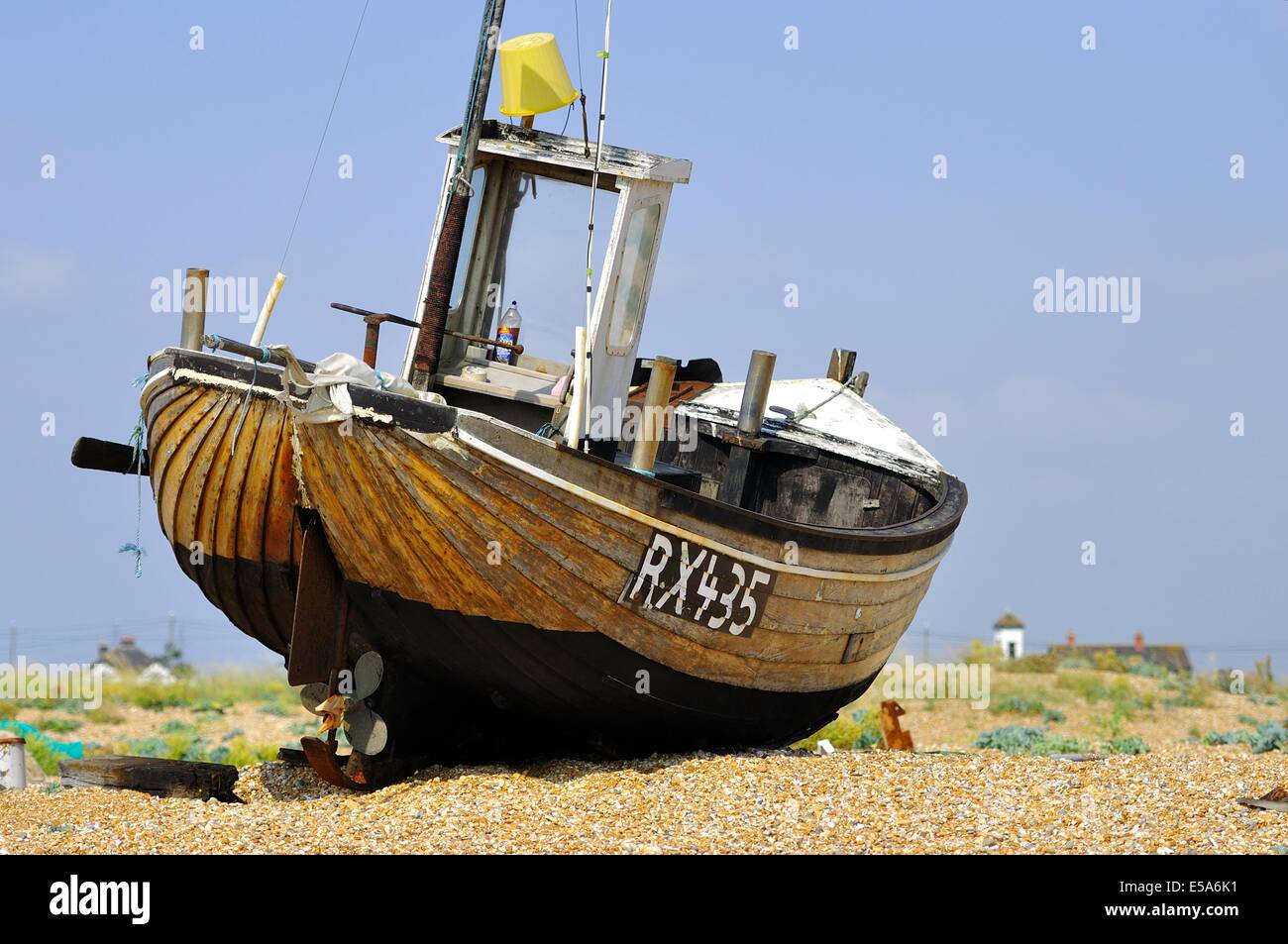 Clinker built fishing boat on shingle beach at Dungeness, Kent, England ...