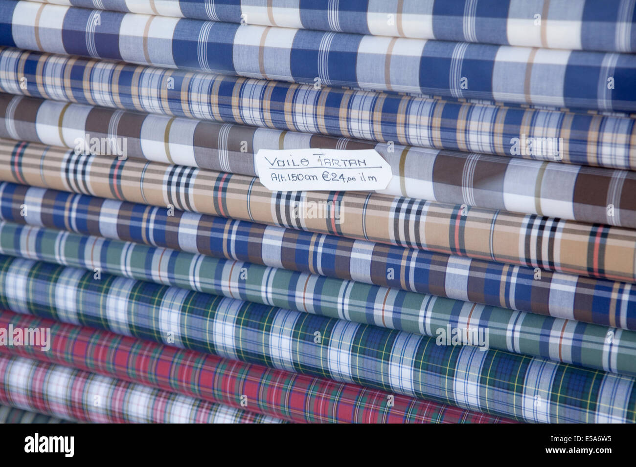 A selection of tartan cloth for sale in a tailors shop window in ...
