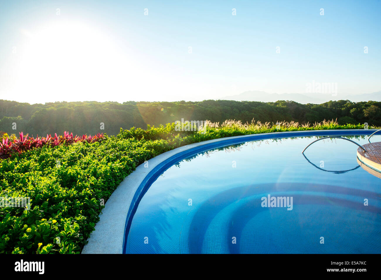 Infinity pool overlooking rural landscape Stock Photo - Alamy
