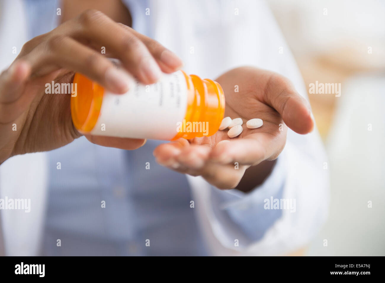 Mixed race doctor taking medication Stock Photo - Alamy