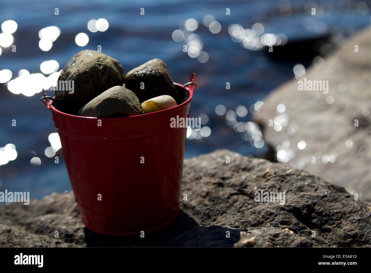 Bucket on top of lakeside rock hi-res stock photography and images - Alamy