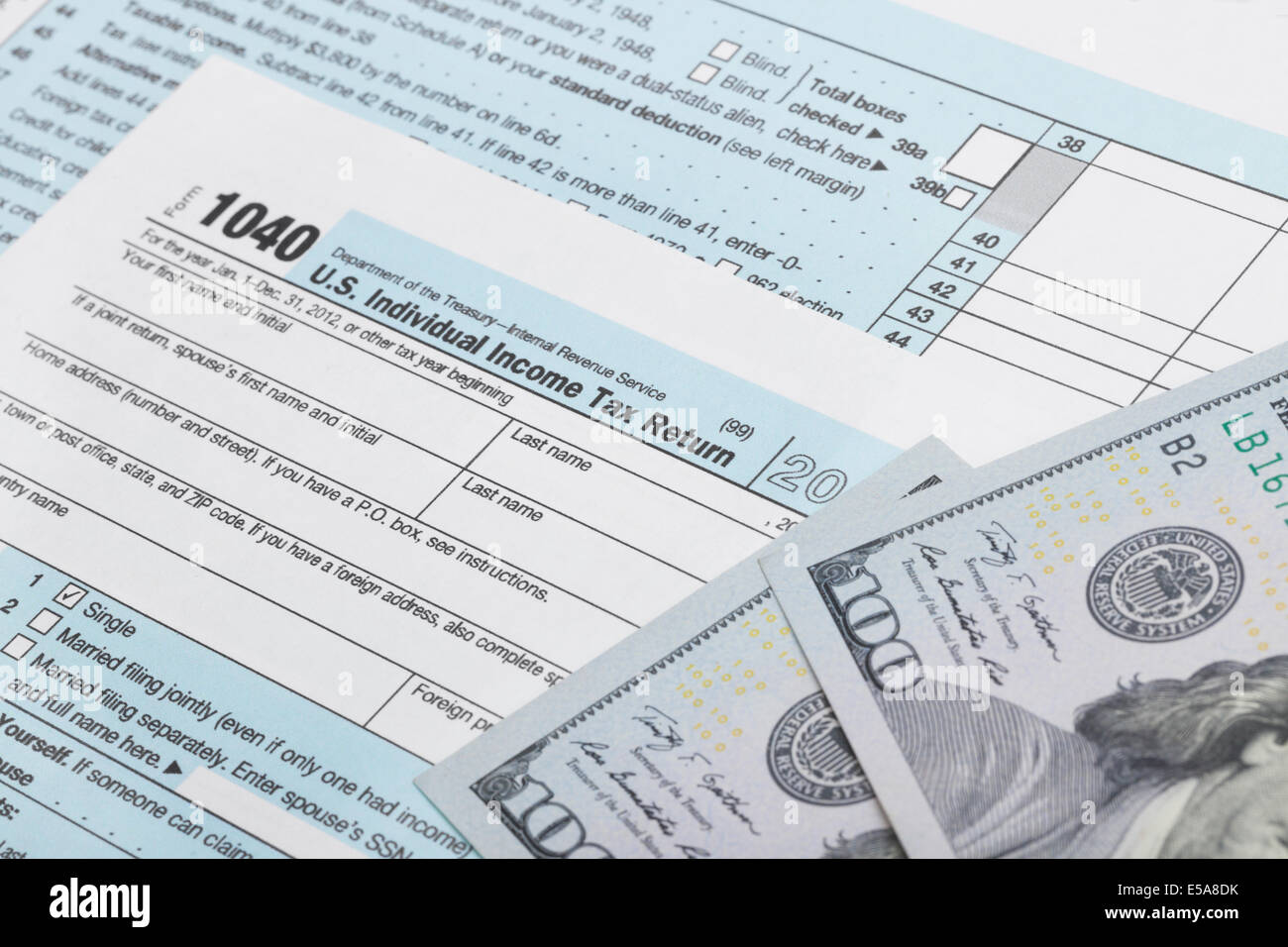 USA Tax Form 1040 with 100 US dollar bills Stock Photo - Alamy