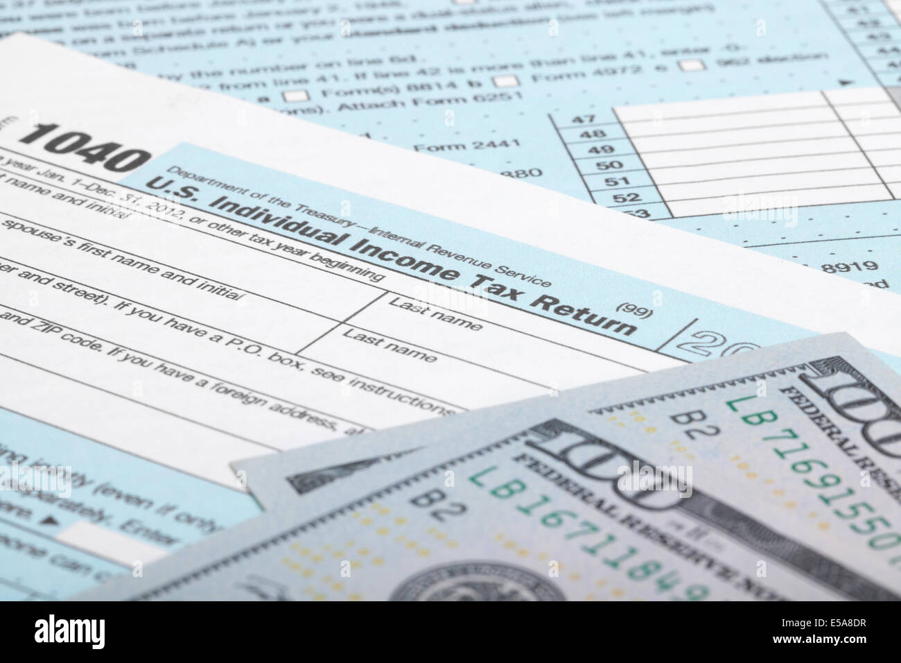 USA Tax Form 1040 with 100 US dollar bills Stock Photo - Alamy