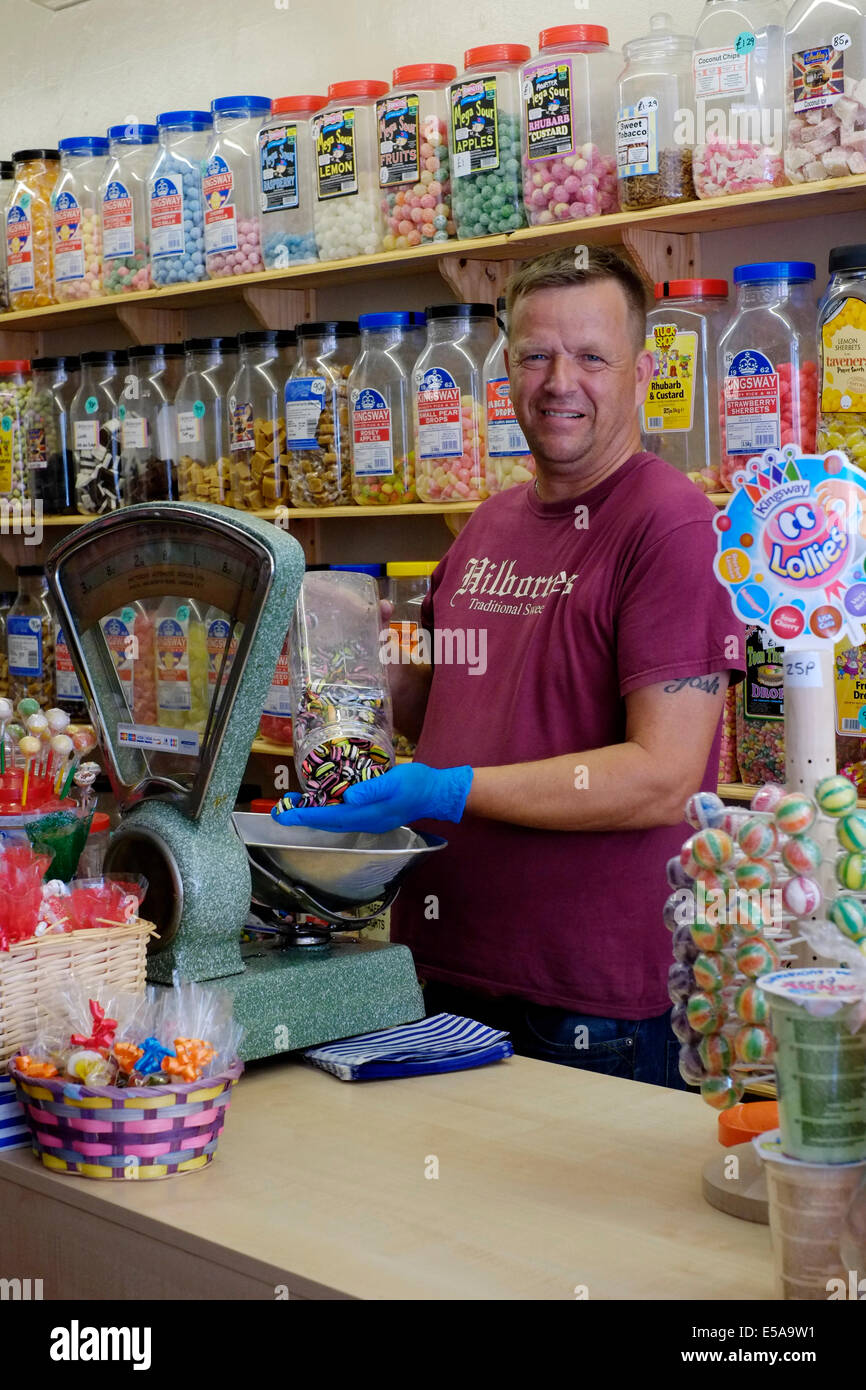 shopkeeper serving sweets at a traditional english sweet shop Stock ...