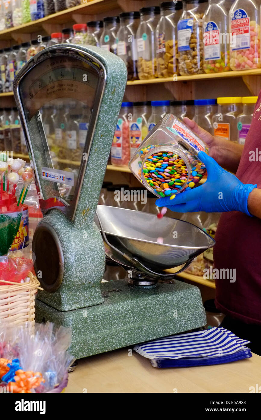 shopkeeper serving sweets at a traditional english sweet shop Stock ...